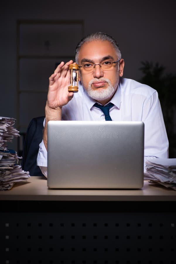 Old Male Employee Working Late at Workplace Stock Photo - Image of ...