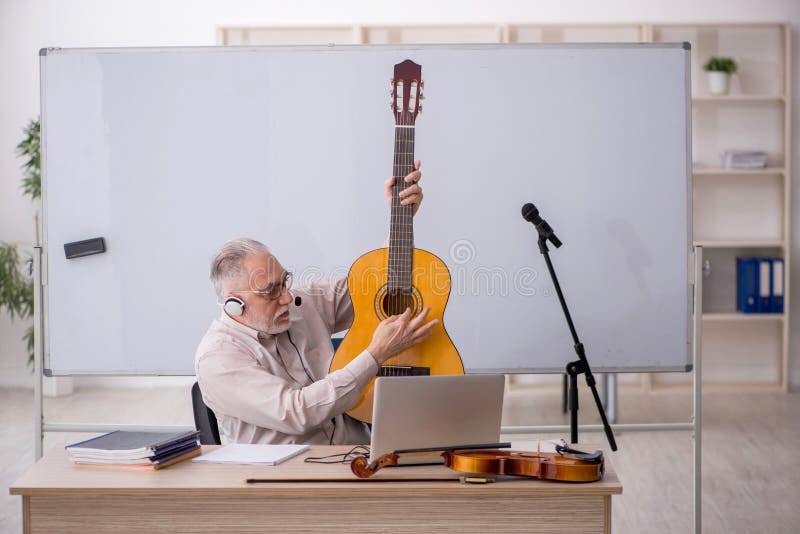 Old Male Music Teacher in the Classroom Stock Image - Image of remote ...