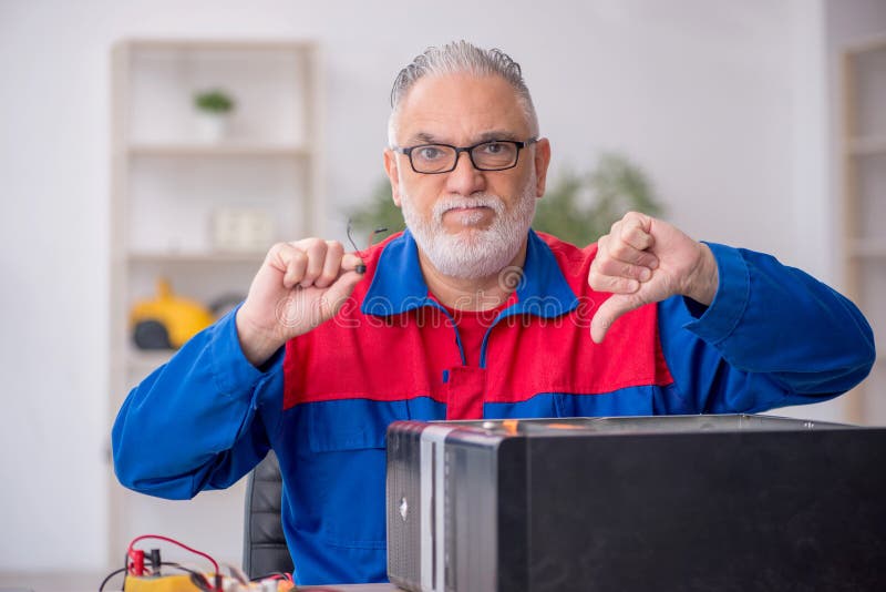 Old Male Repairman Repairing Computer Stock Photo - Image of repairing ...