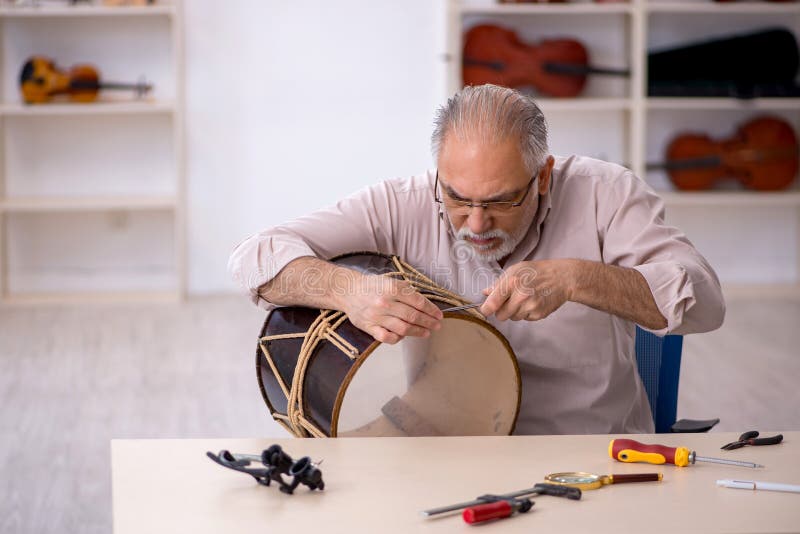 Old Male Repairman Repairing Musical Instruments at Workshop Stock ...
