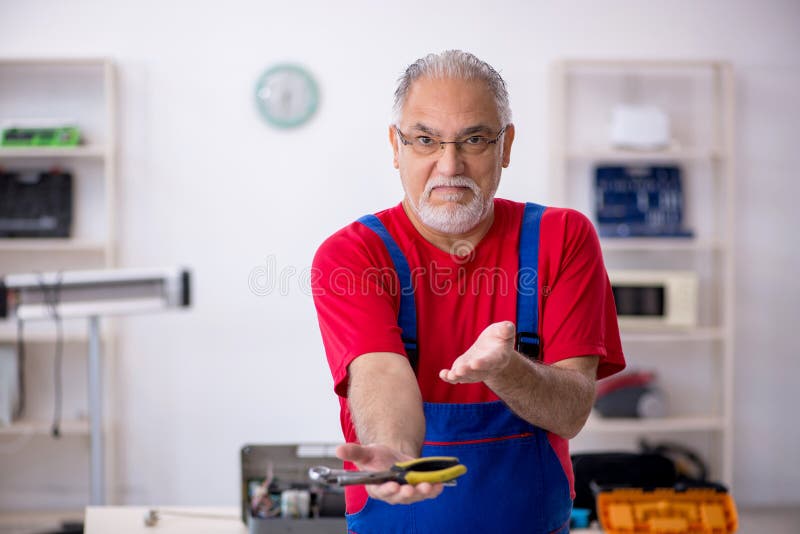 Old Male Repairman at Workshop Stock Image - Image of repair, pliers ...
