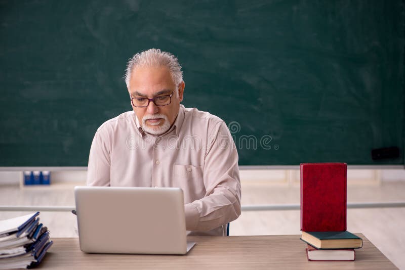 Old Male Teacher in Front of Green Board Stock Image - Image of ...