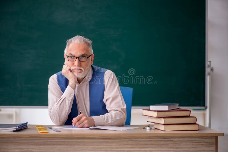 Old Male Teacher in Front of Green Board Stock Image - Image of papers ...