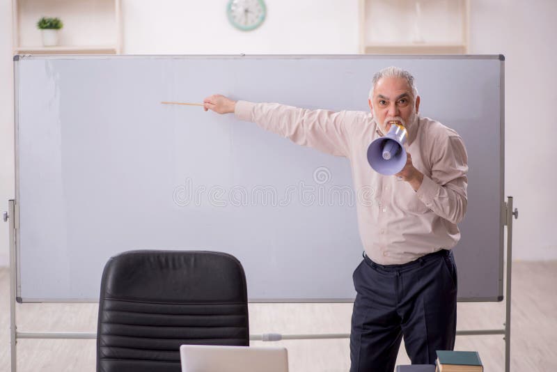 Old Male Teacher Holding Megaphone in the Classroom Stock Image - Image ...