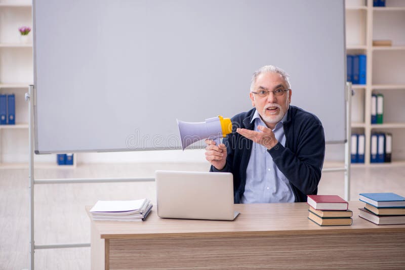 Old Male Teacher Holding Megaphone in the Classroom Stock Photo - Image ...