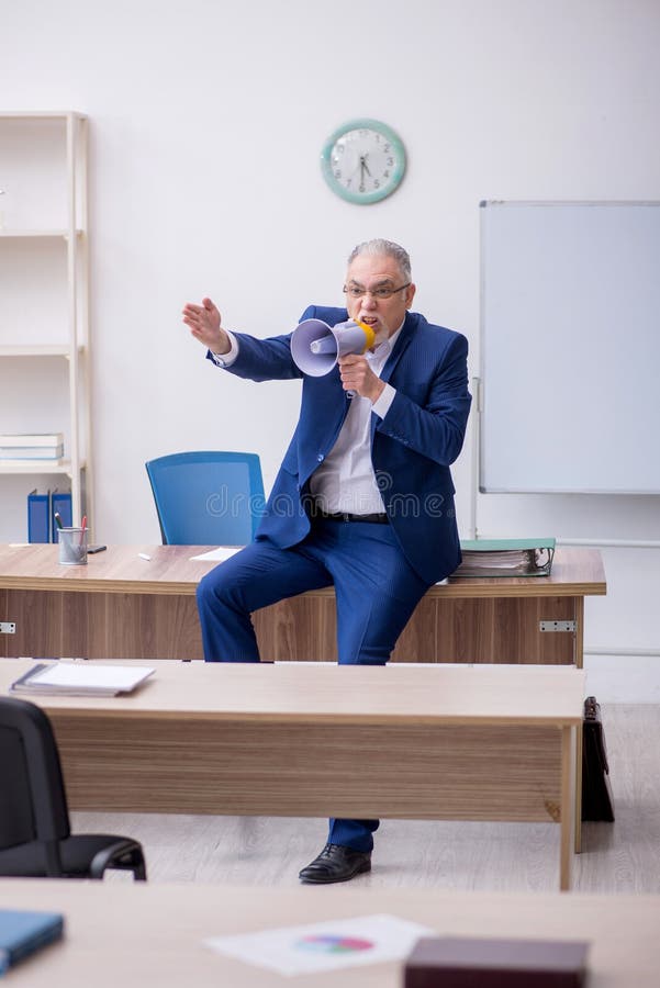 Old Male Teacher Holding Megaphone in the Classroom Stock Image - Image ...