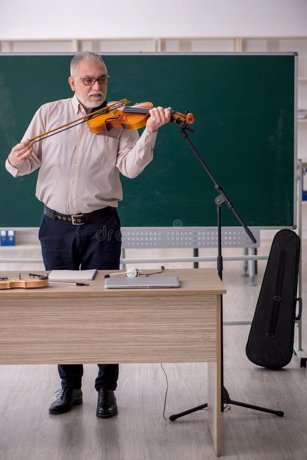 Old Male Teacher Playing Violin in the Classroom Stock Image - Image of viola, string: 274136949