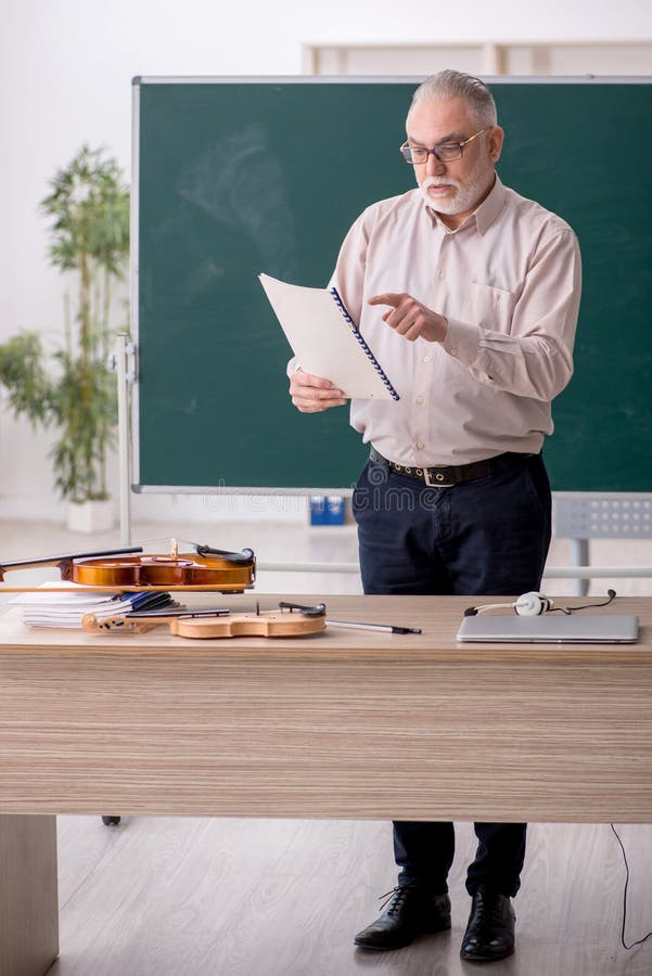 Old Male Teacher Playing Violin in the Classroom Stock Photo - Image of ...