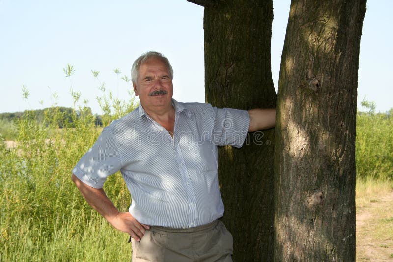 Happy Old Man Sitting Under Tree in the Forest Stock Photo - Image of ...