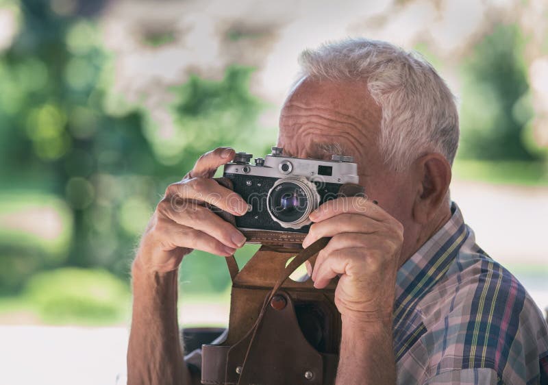 Old man with analog camera stock photo. Image of antique - 148272526
