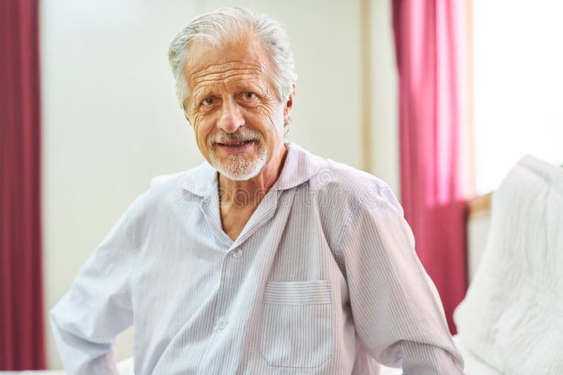 Old Man As a Senior Sits in the Bed of the Nursing Home Stock Photo ...