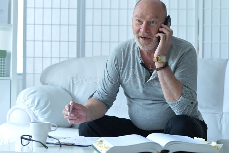 Old Man with Book Talking on Phone and Taking Notes Stock Photo - Image ...
