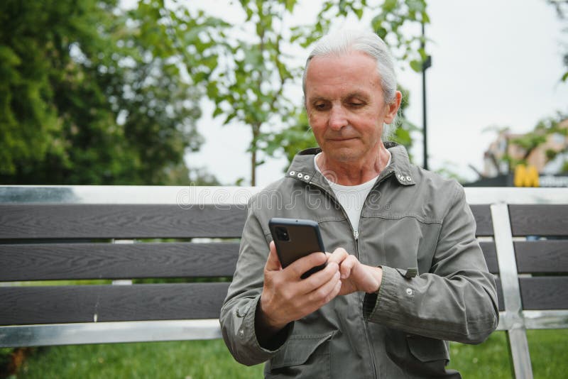 Old Man Browsing App on Smartphone, Outdoor in Park Stock Photo - Image ...