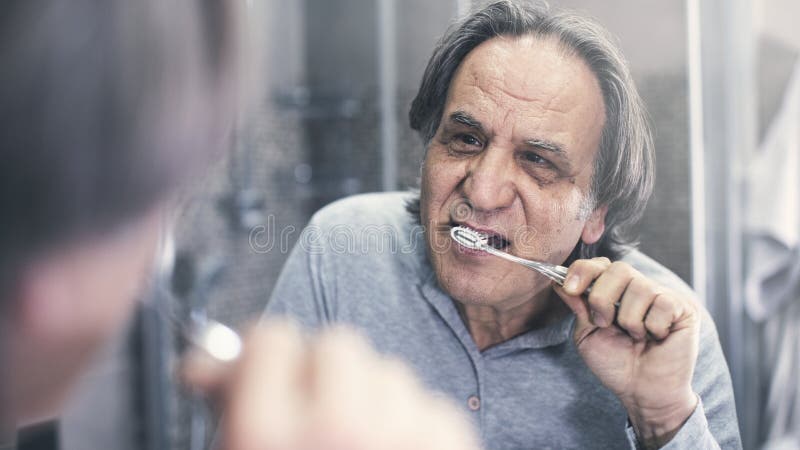 Old Man Brushing Teeth in Front of the Mirror Stock Image - Image of ...