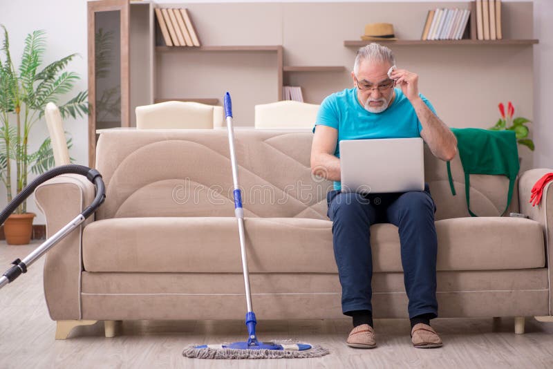 Old man cleaning the house stock image. Image of house - 224015115