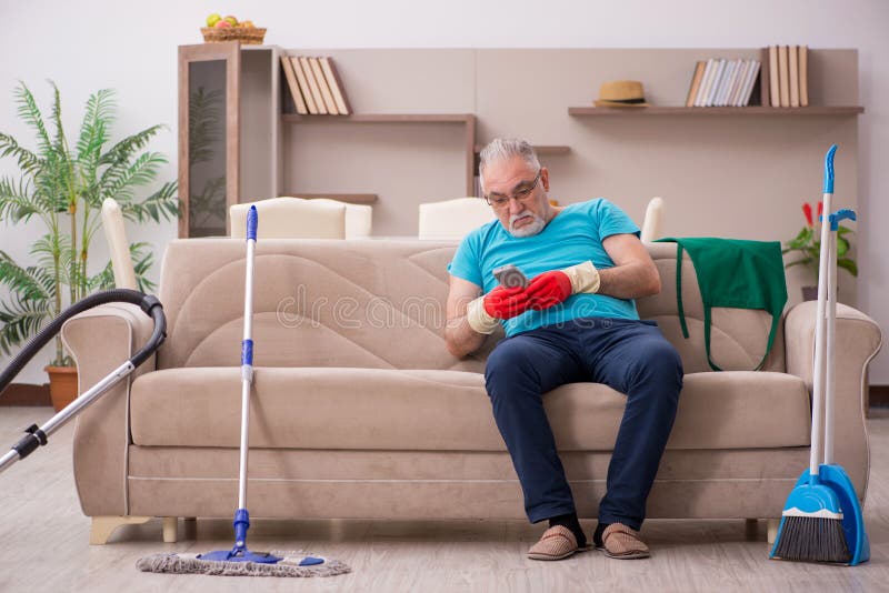 Old man cleaning the house stock photo. Image of house - 227546848