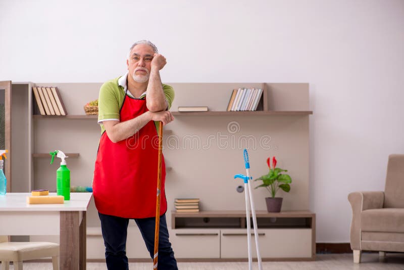Old man cleaning the house stock image. Image of clean - 230702327