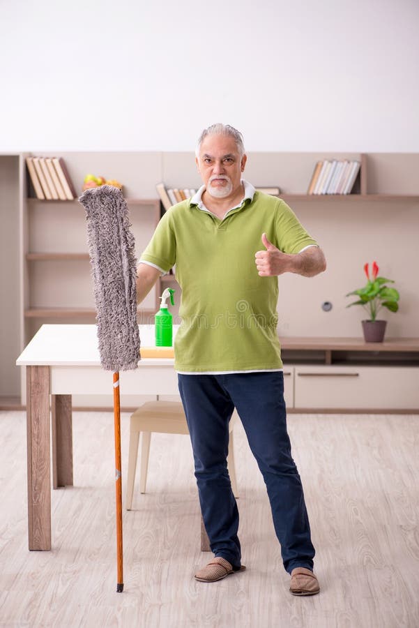 Old man cleaning the house stock image. Image of housework - 239758321