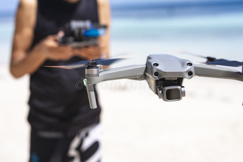 An Old Man Controlling a Small Drone at the Beach. a Hobbyist Drone ...