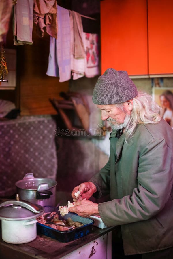 Old man cooking meat stock image. Image of inside, indoors - 91540717