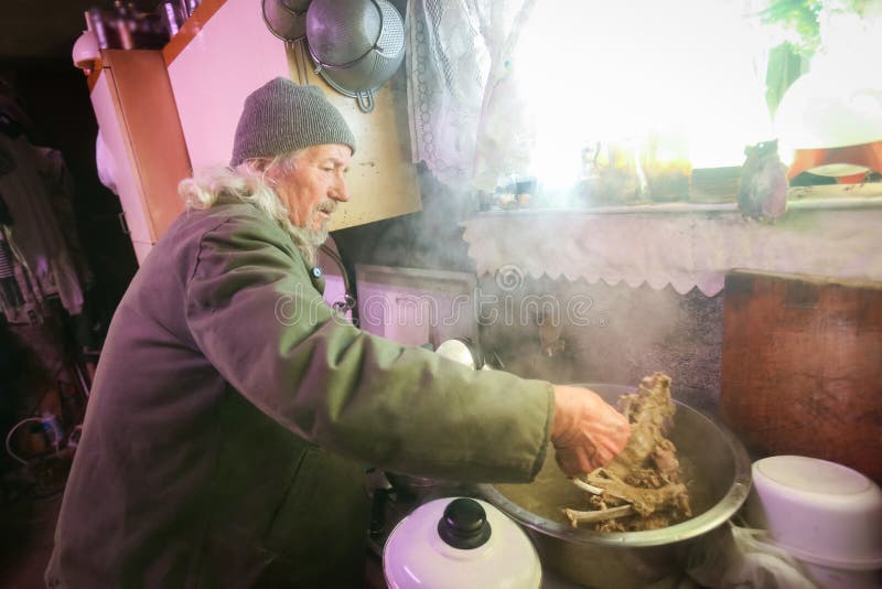 Old man cooking pork stock photo. Image of beard, gray - 91540736