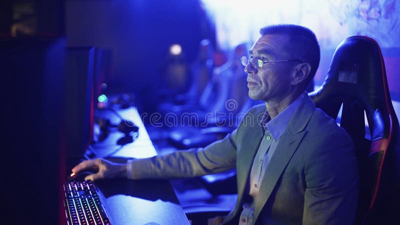 Old Man Playing on Computer Late at Night in Modern Computer Club ...