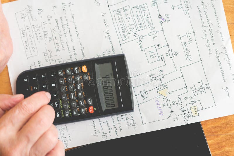 Old Man Doing Some Math Calculations Using Digital Calculator at His ...