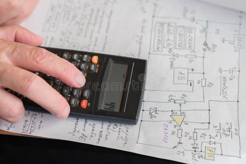 Old Man Doing Some Math Calculations Using Digital Calculator at His ...