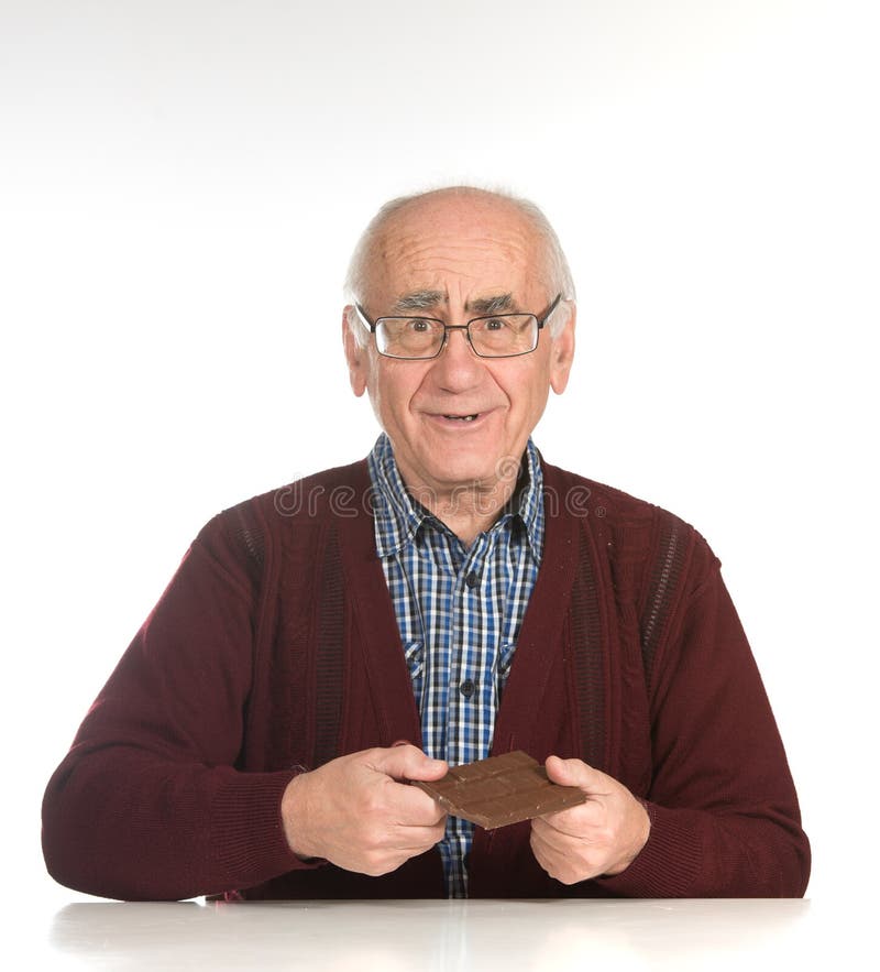 Young man eating chocolate stock image. Image of mouth - 8190799