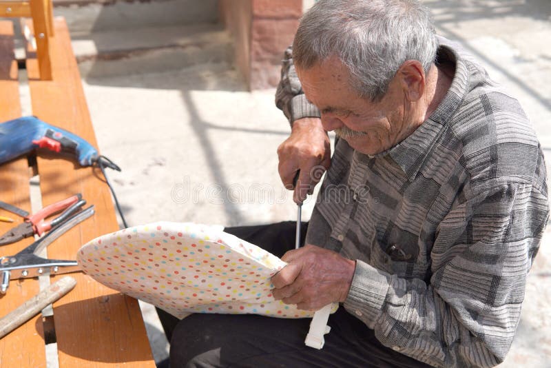 Old Man Fixing Broken Chair with Screwdriver Stock Photo - Image of ...