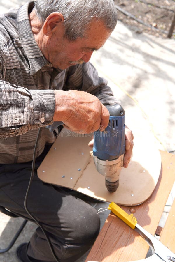 Old Man Fixing Child Chair, Outdoor Stock Photo - Image of backyard ...