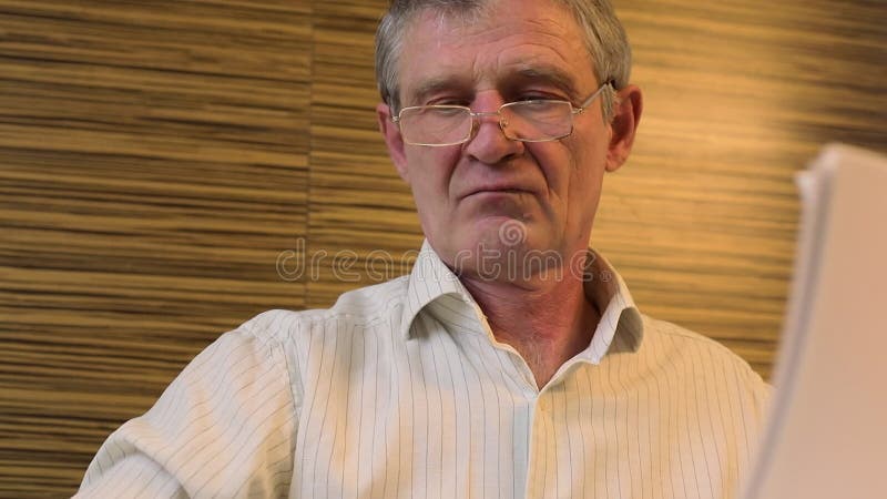 Old Man in Glasses Puts Together Stack of Paper. Stock Footage - Video ...