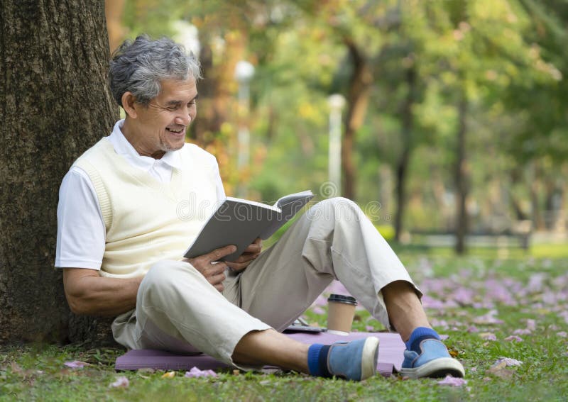 Mature Male with Grey Hair Smiling and Sitting at the Forest Park on ...