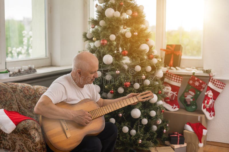 Old Man with a Guitar at Christmas Stock Image - Image of fashion, five ...