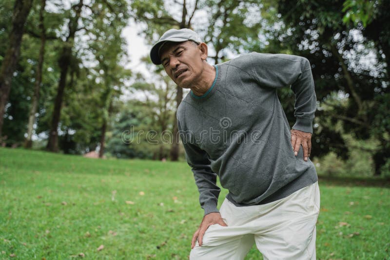 Old Man Having Back Pain while in the Park Stock Photo - Image of ...