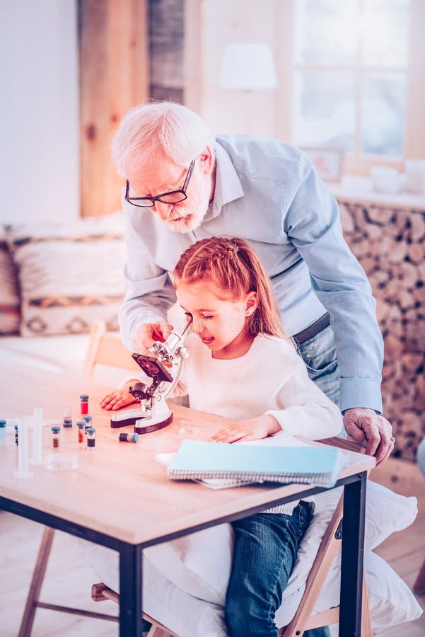 Old Man Helping Kid Watching in Microscope Stock Photo - Image of ...