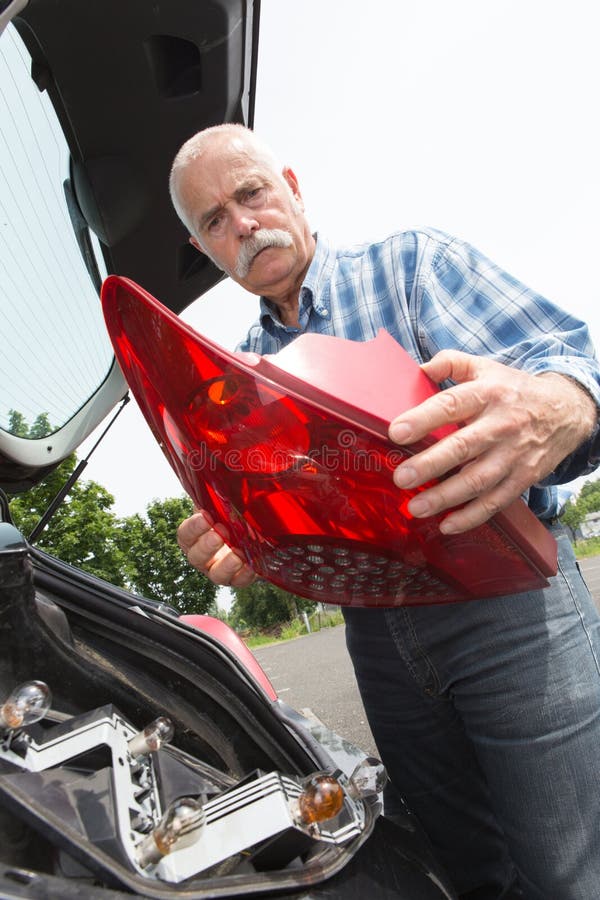 Old Man Installs Tail Light on Vehicle Stock Image - Image of ...