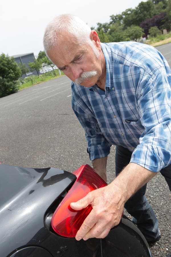 Old Man Installs Tail Light on Vehicle Stock Image - Image of broken ...