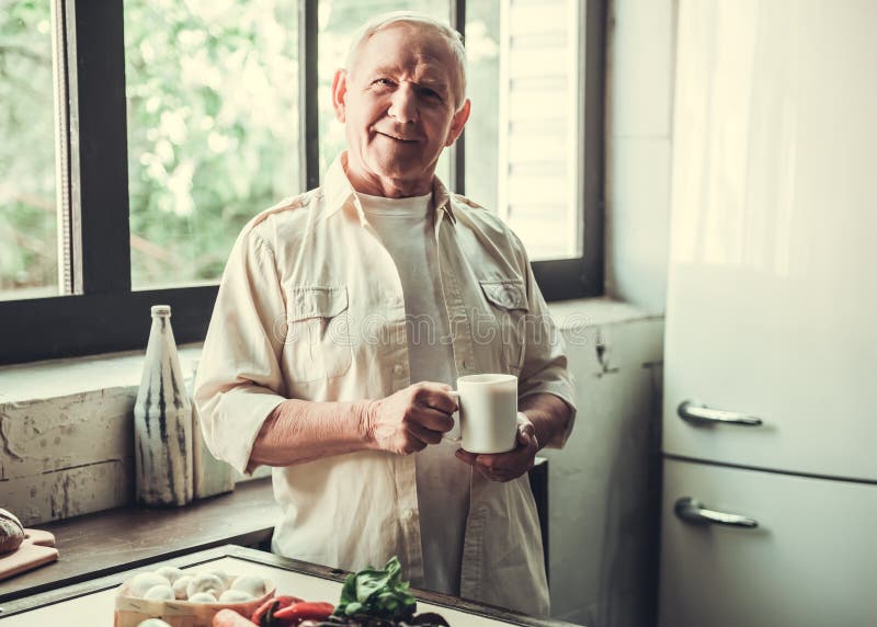 Old man in kitchen stock photo. Image of handsome, meal - 97136538