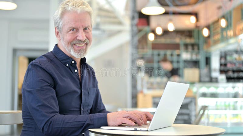 Old Man with Laptop Smiling at Camera in Cafe Stock Photo - Image of ...