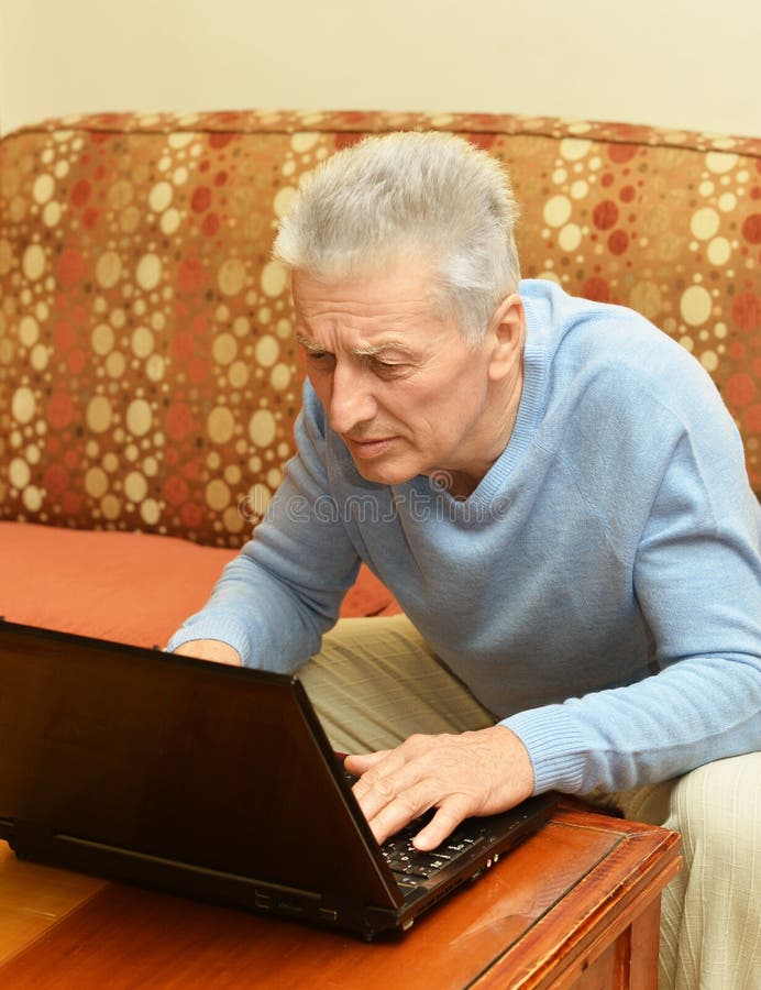 Old man with laptop stock photo. Image of person, shirt - 45640844