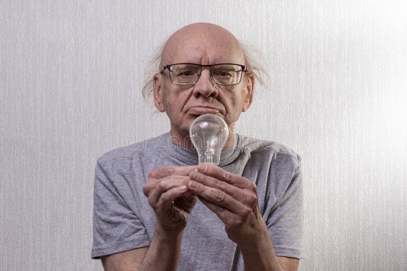 Old Man with Light Bulb. Portrait. Incandescent in Old Hands. Idea ...