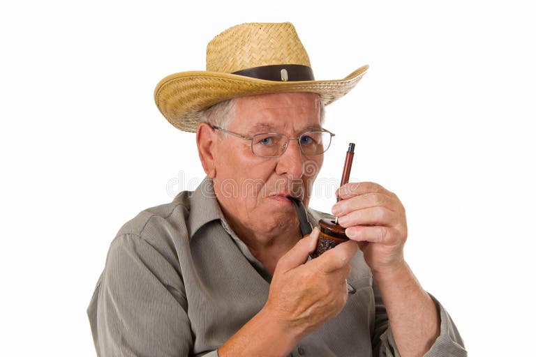 Old man lighting up a pipe stock photo. Image of face - 27960954