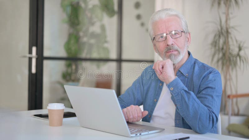 Senior Old Man Looking at Camera while Using Laptop in Office Stock ...