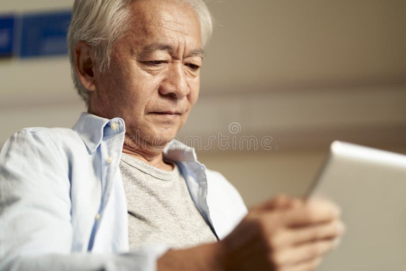 Old Man Looking at Digital Tablet Stock Image - Image of asian, living ...