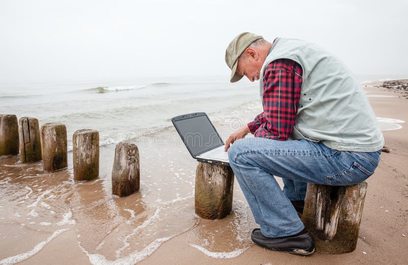 Old Man with Notebook on Beach Stock Photo - Image of notebook, laptop ...