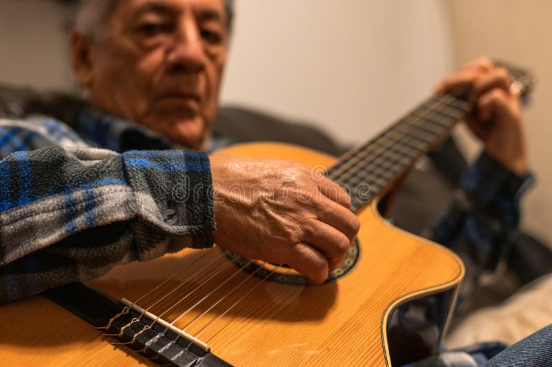 Old Man Playing Acoustic Guitar and Sitting on Sofa. Stock Photo ...