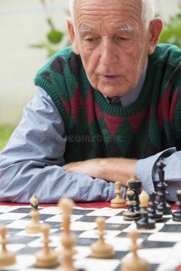 Old man playing chess stock photo. Image of expression - 78602728
