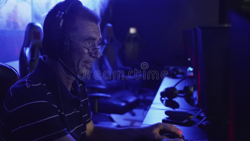 Old Man Playing on Computer Late at Night in Modern Computer Club ...