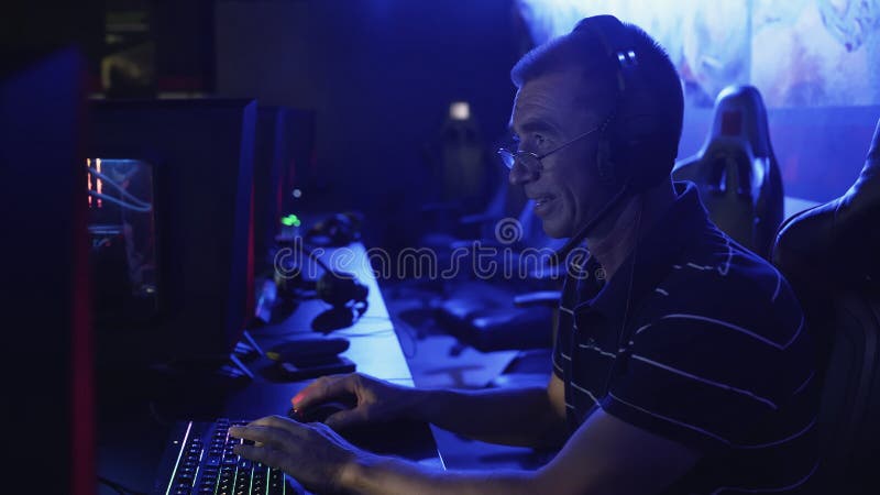 Old Man Playing on Computer Late at Night in Modern Computer Club ...